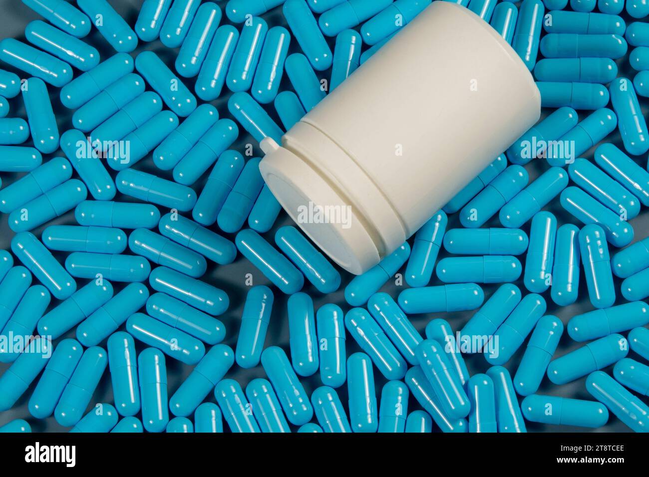 Blue antibiotic capsule pills texture with white bottle. Pharmaceutical ...