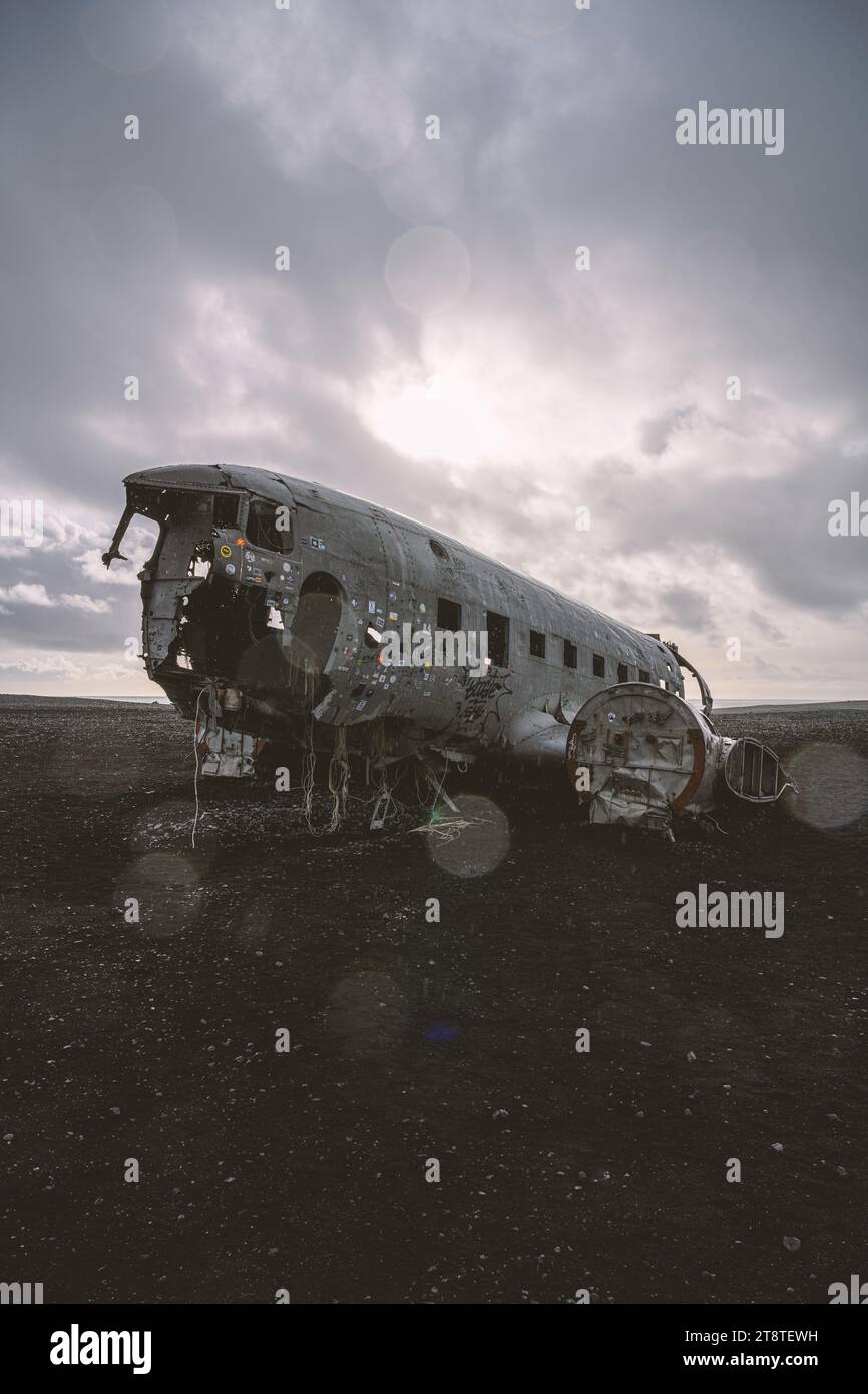 A commercial airplane is pictured in a rural landscape, its wingspan ...