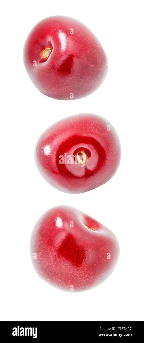 Cherries, three red cherry berries, falling, hanging, flying, soaring ...