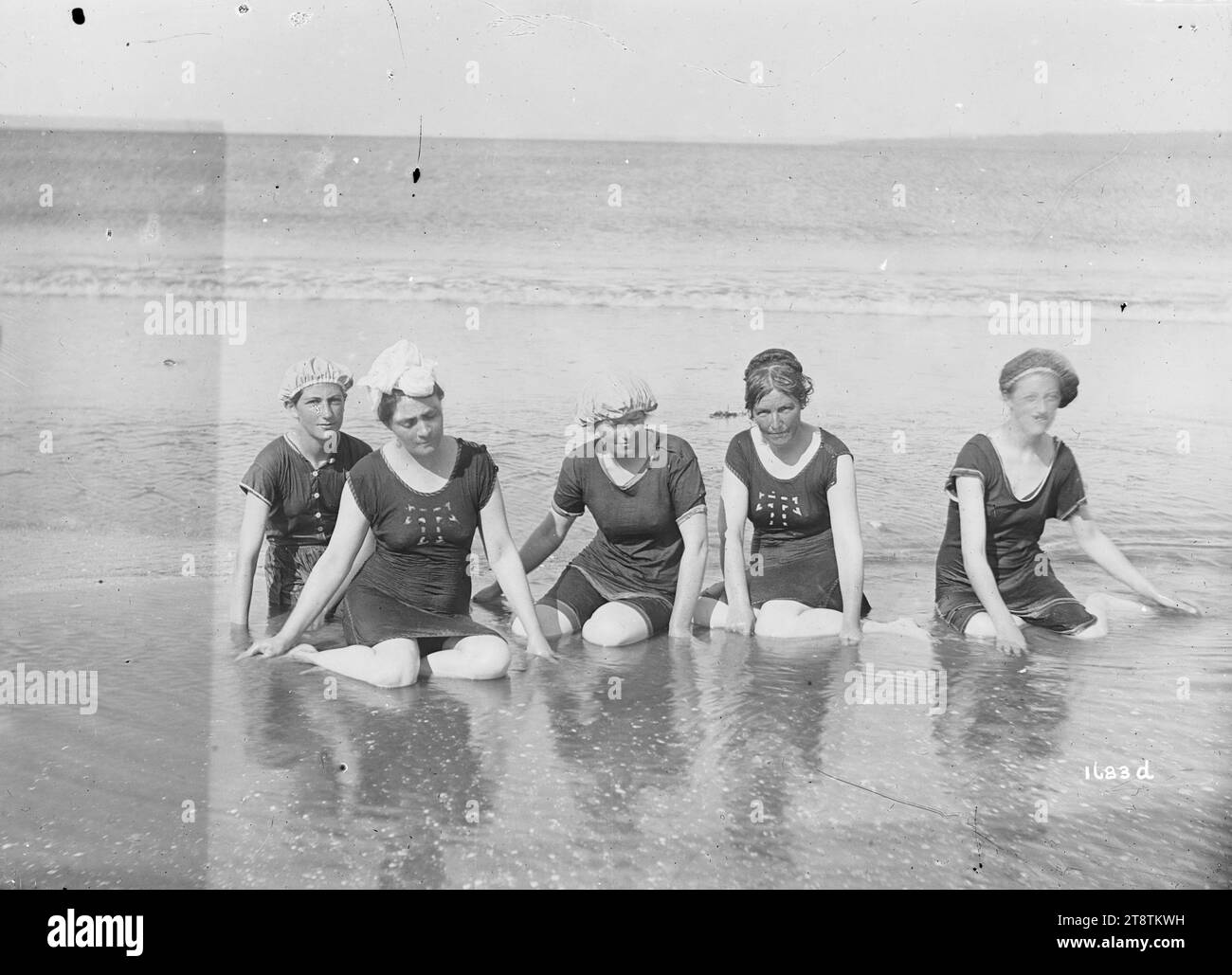 Bathing in the sea, Five unidentified young women sitting together in ...