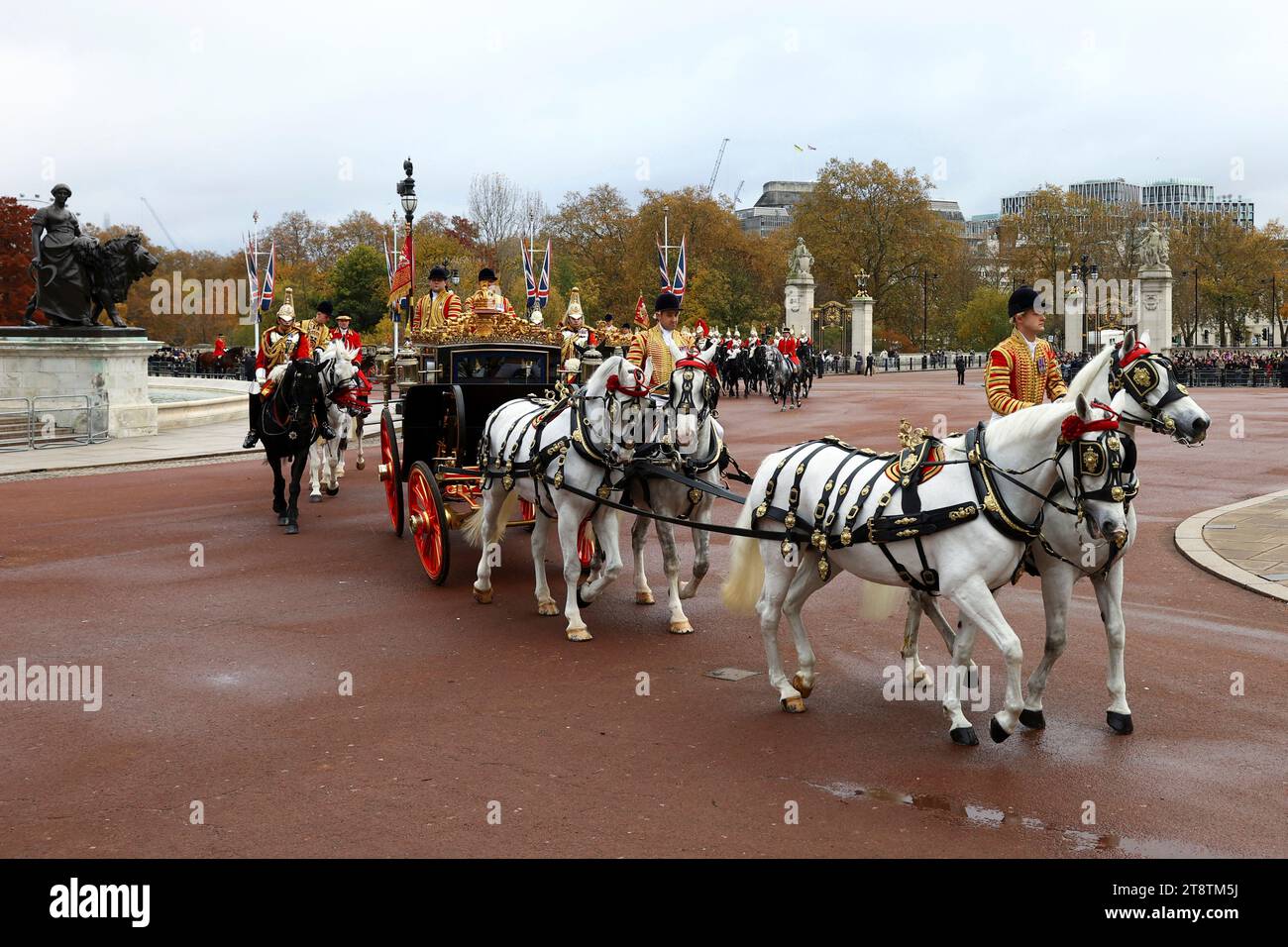A procession with a royal carriage returns to Buckingham palace after a ...
