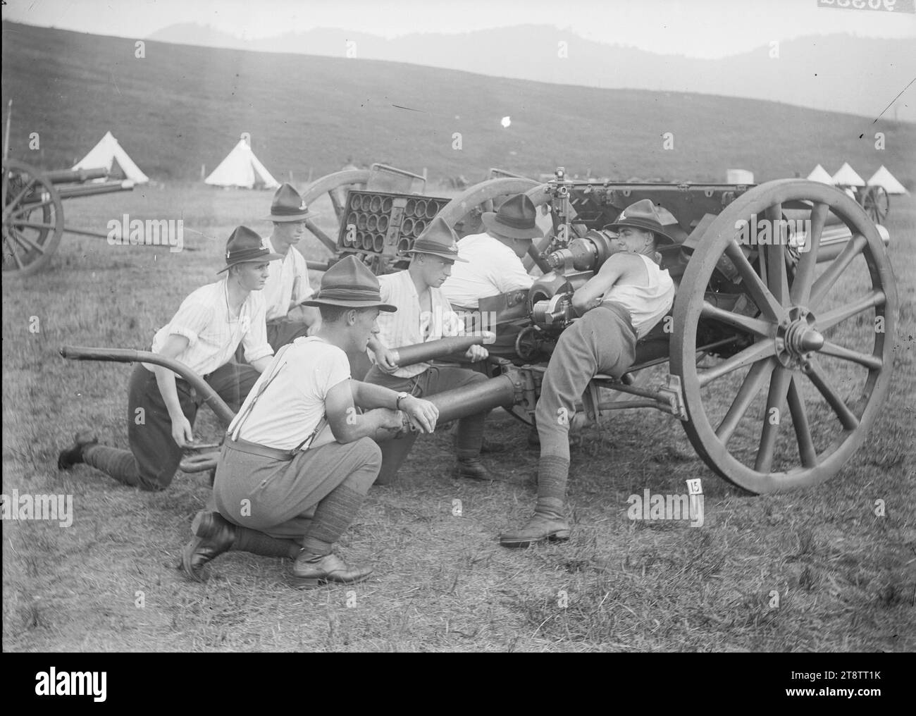 Artillery practice, View of six soldiers loading a field gun during artillery practice at a ...