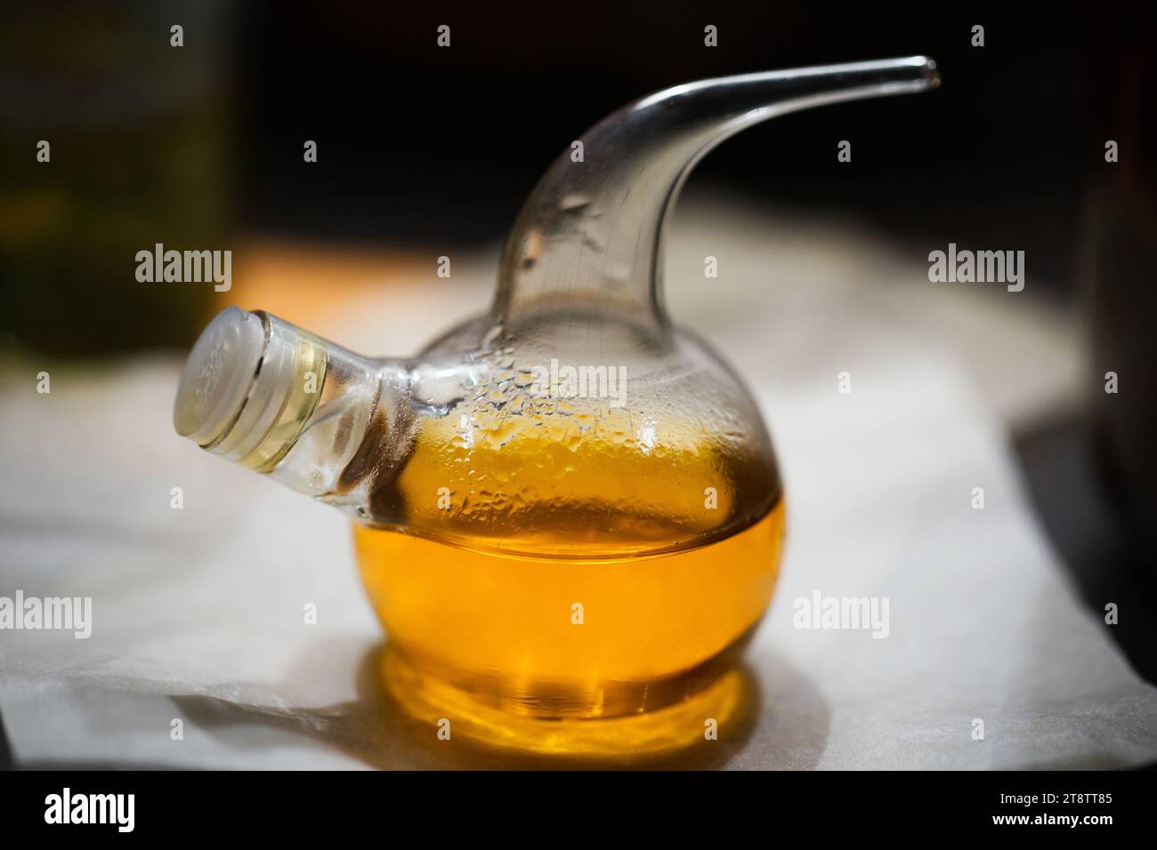 Retort old, glass medical antique pharmacy vessel with yellow liquid ...