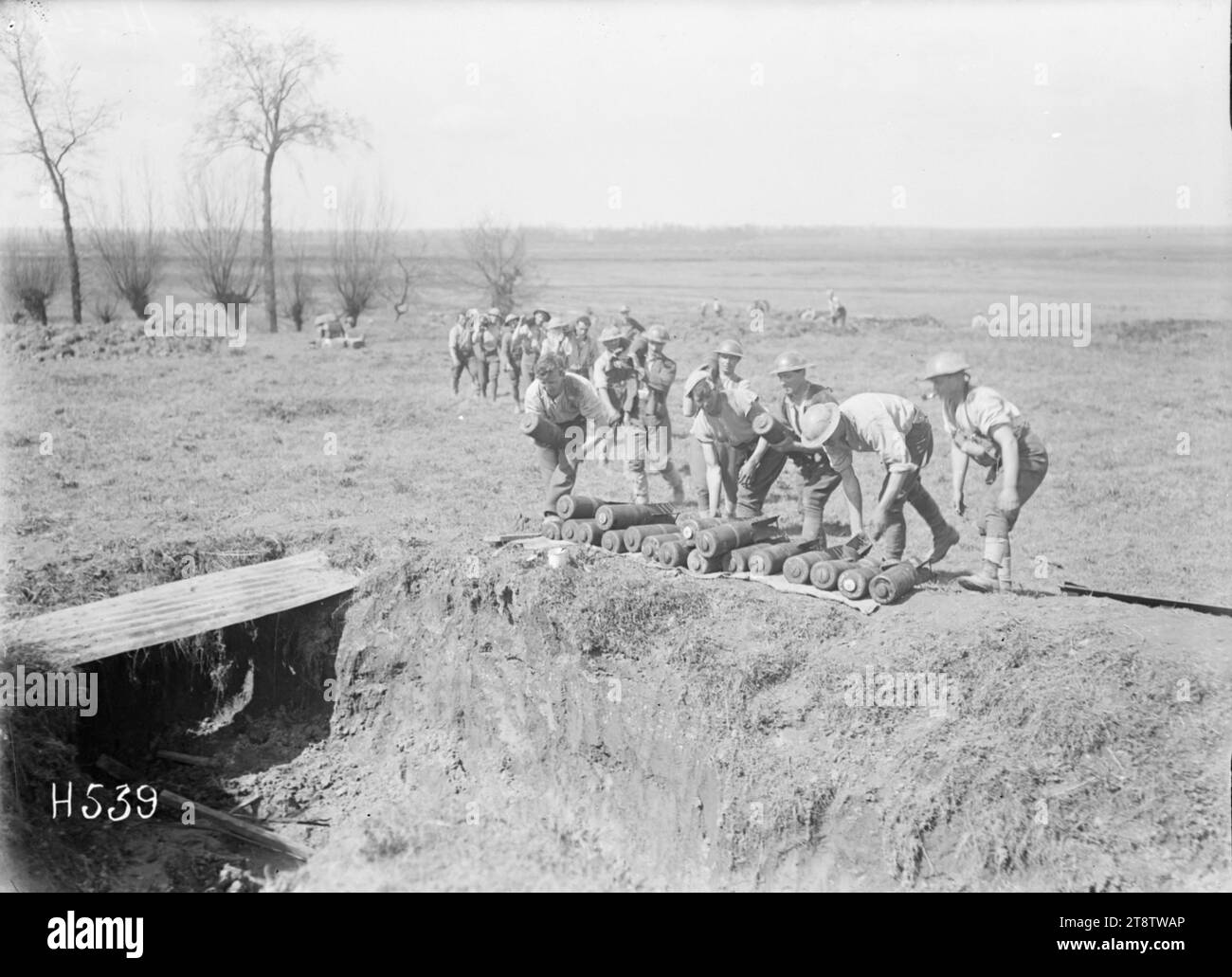 Soldiers carry mortar shells across open ground hi-res stock ...