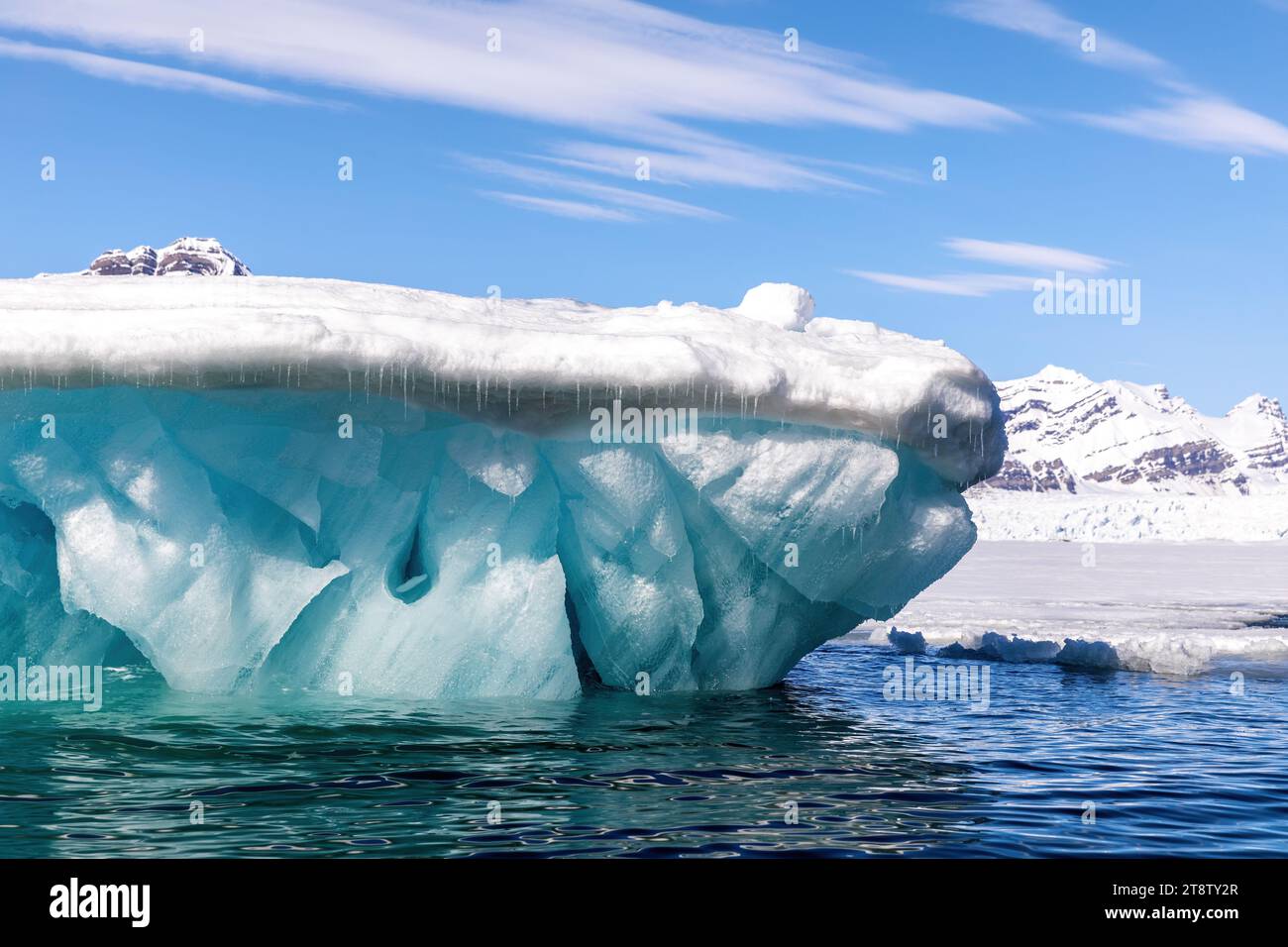 Glacial blue iceberg and sky background. Underside of a snow covered ...
