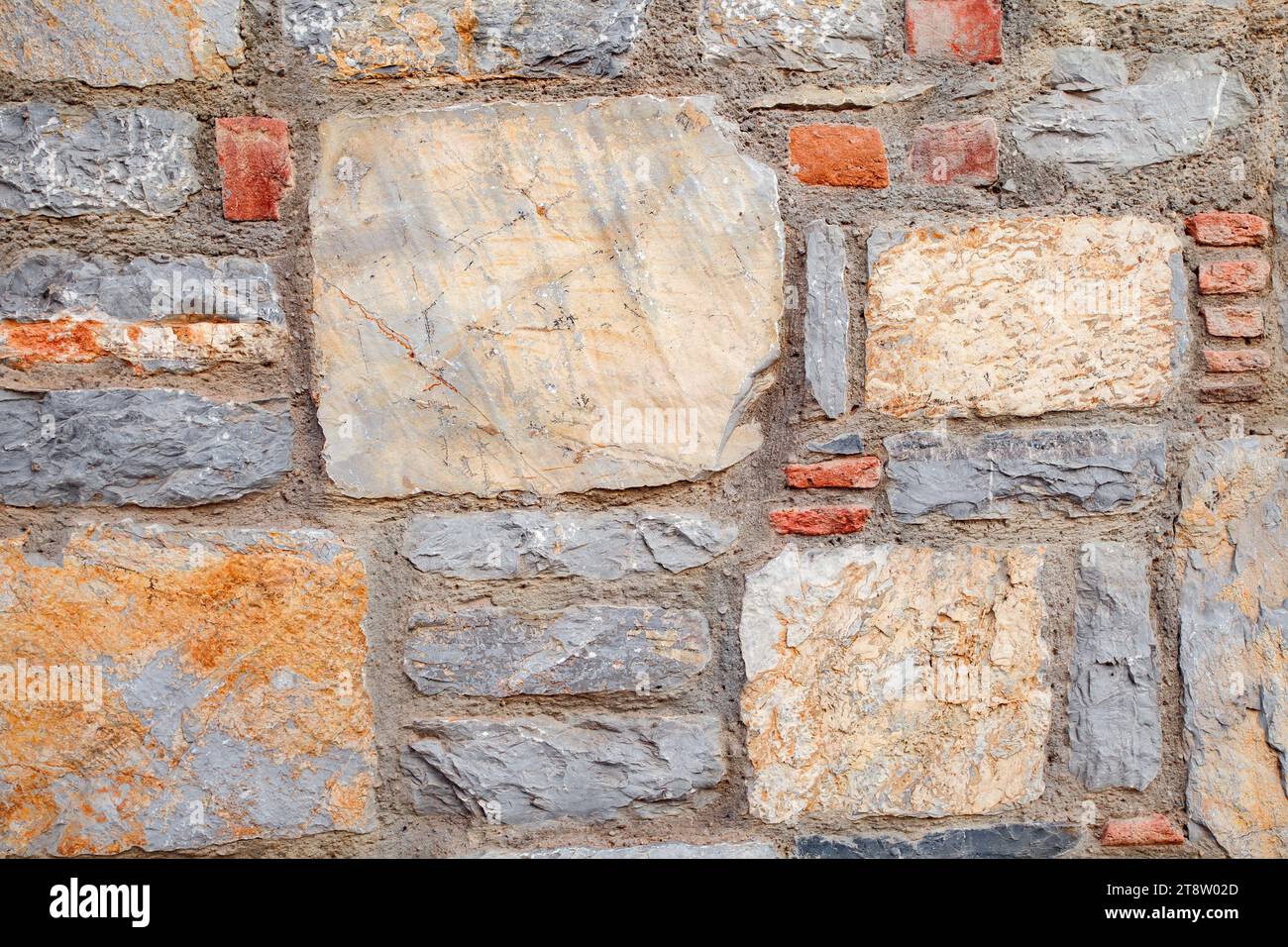 Wall from bricks, rectangular and square different stones, texture of ...