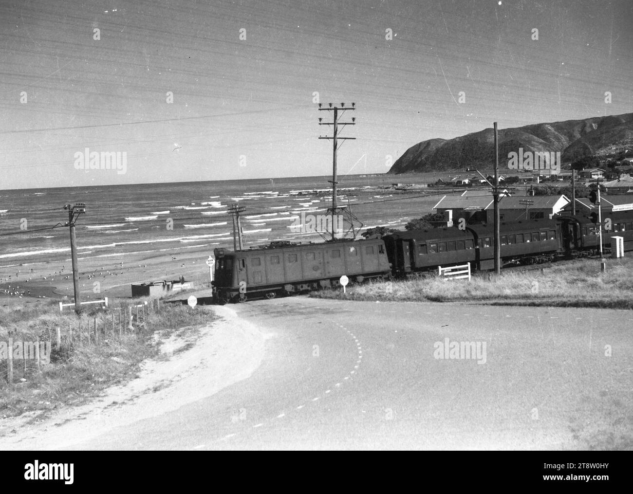 A passenger train passing through a railway crossing at Plimmerton, ca ...