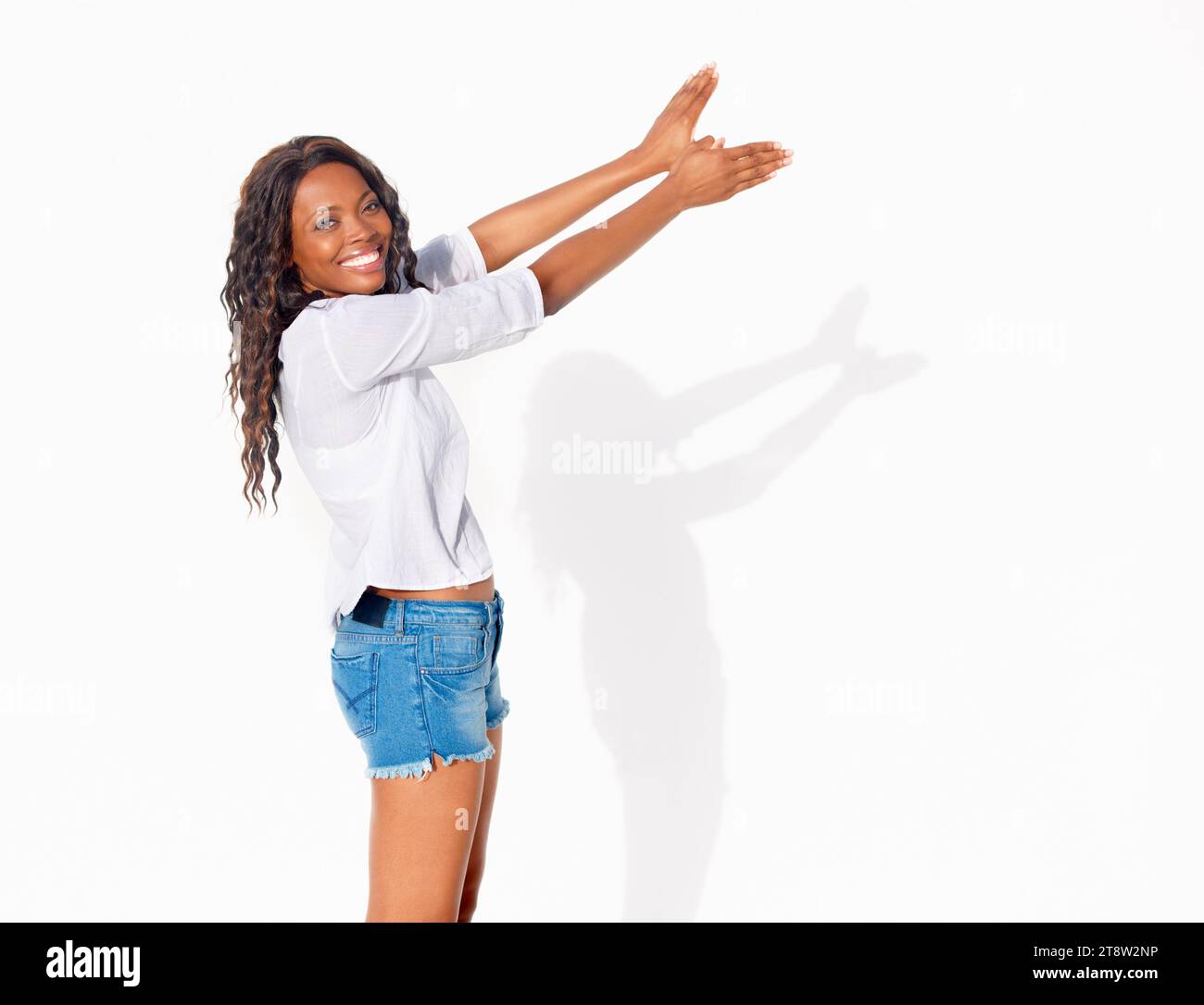 Bird shadow, black woman and portrait with hands in wings shape flying ...