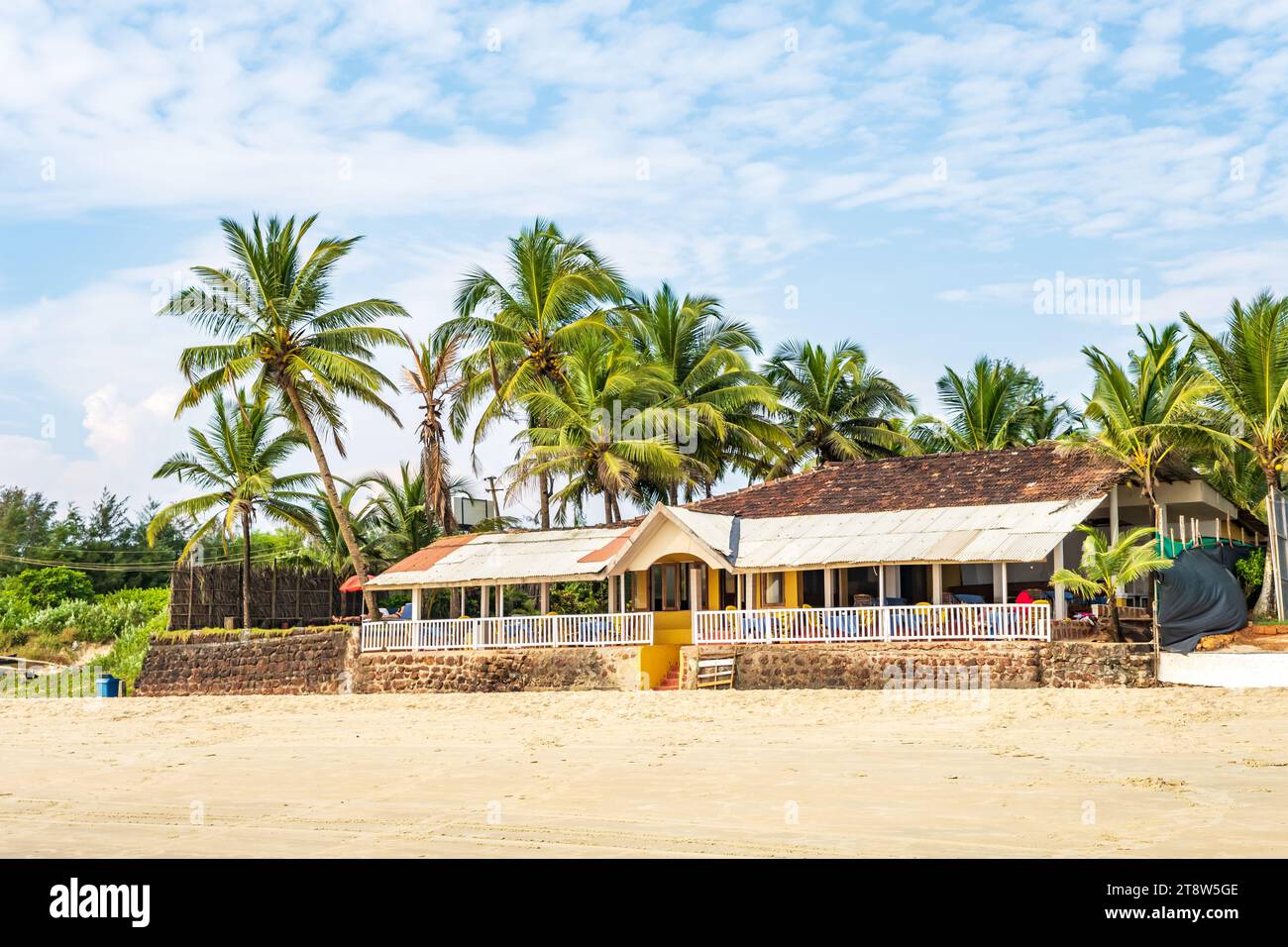 coconut trees on ocean coast near tropical shack or open cafe on beach ...