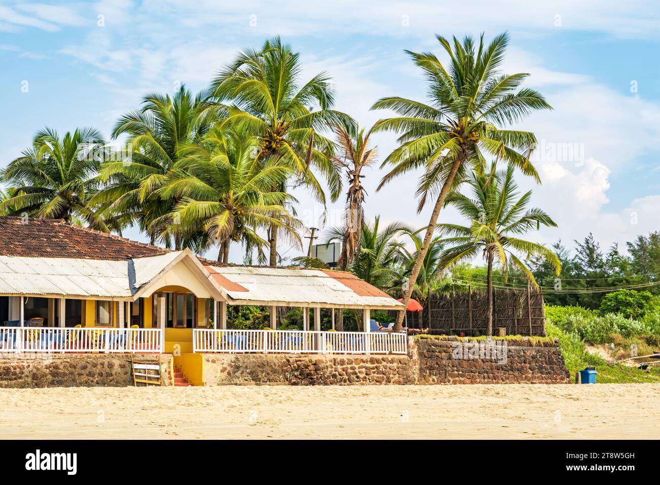 coconut trees on ocean coast near tropical shack or open cafe on beach ...
