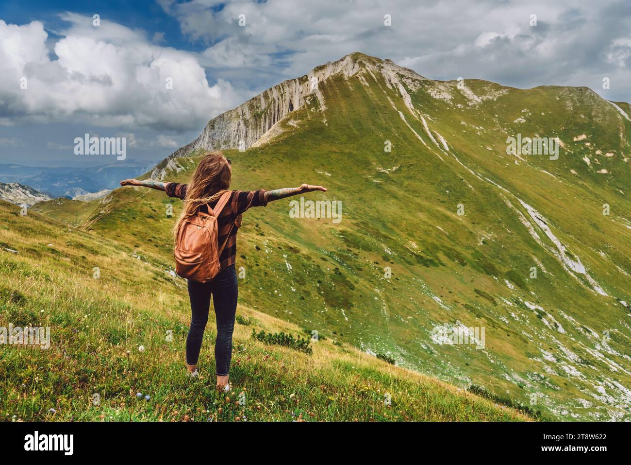 Woman Solo Travel Raised Hands in Mountains Stock Photo - Alamy