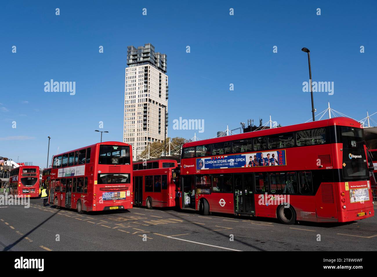 Local people and red London buses at the major Transport for London ...