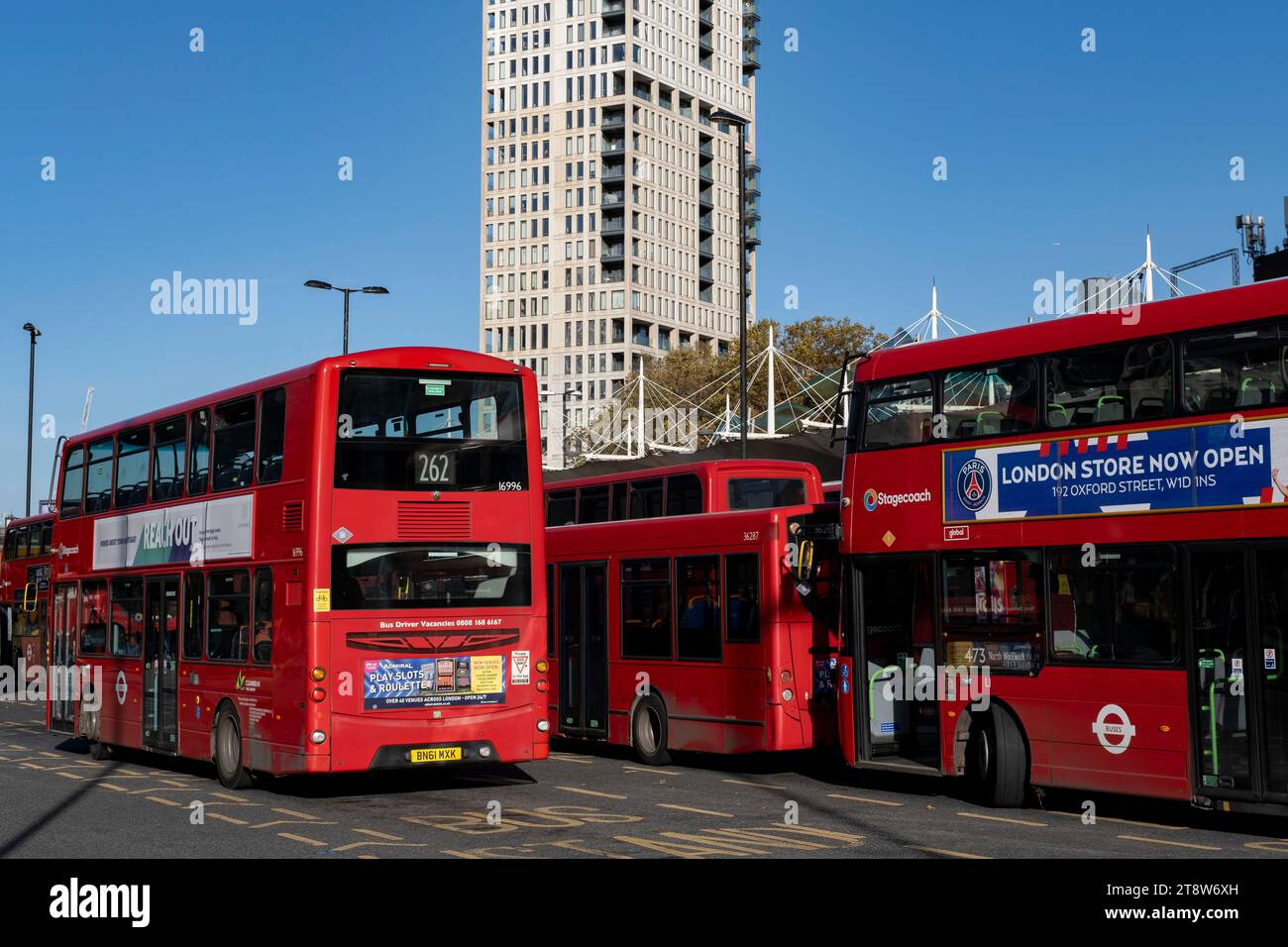 Local people and red London buses at the major Transport for London ...