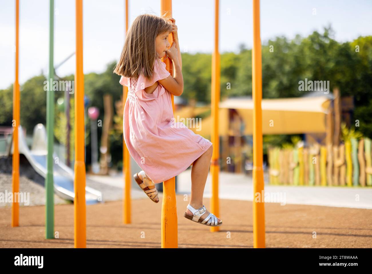 Happy little girl playing on a children's playground Stock Photo - Alamy