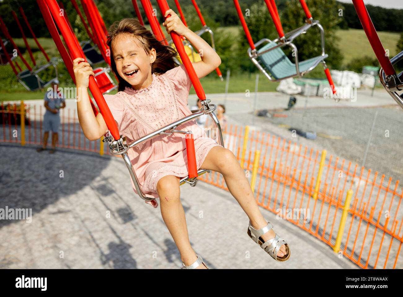Kids riding on colorful amusement carousel Stock Photo - Alamy