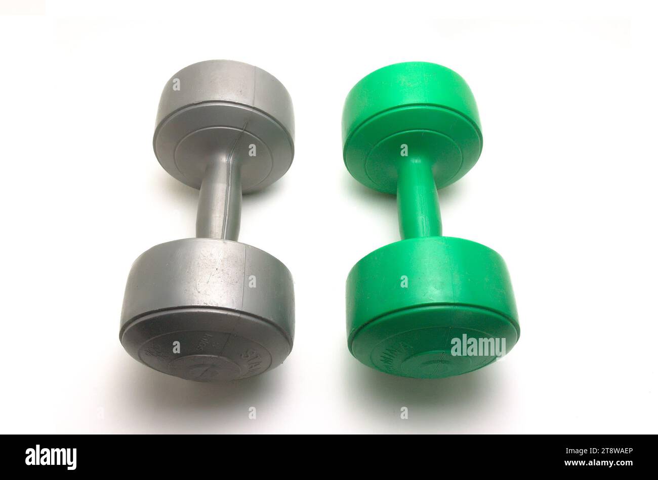 Two 5 kg dumbbell barbells in gray and green on a white background Stock Photo - Alamy