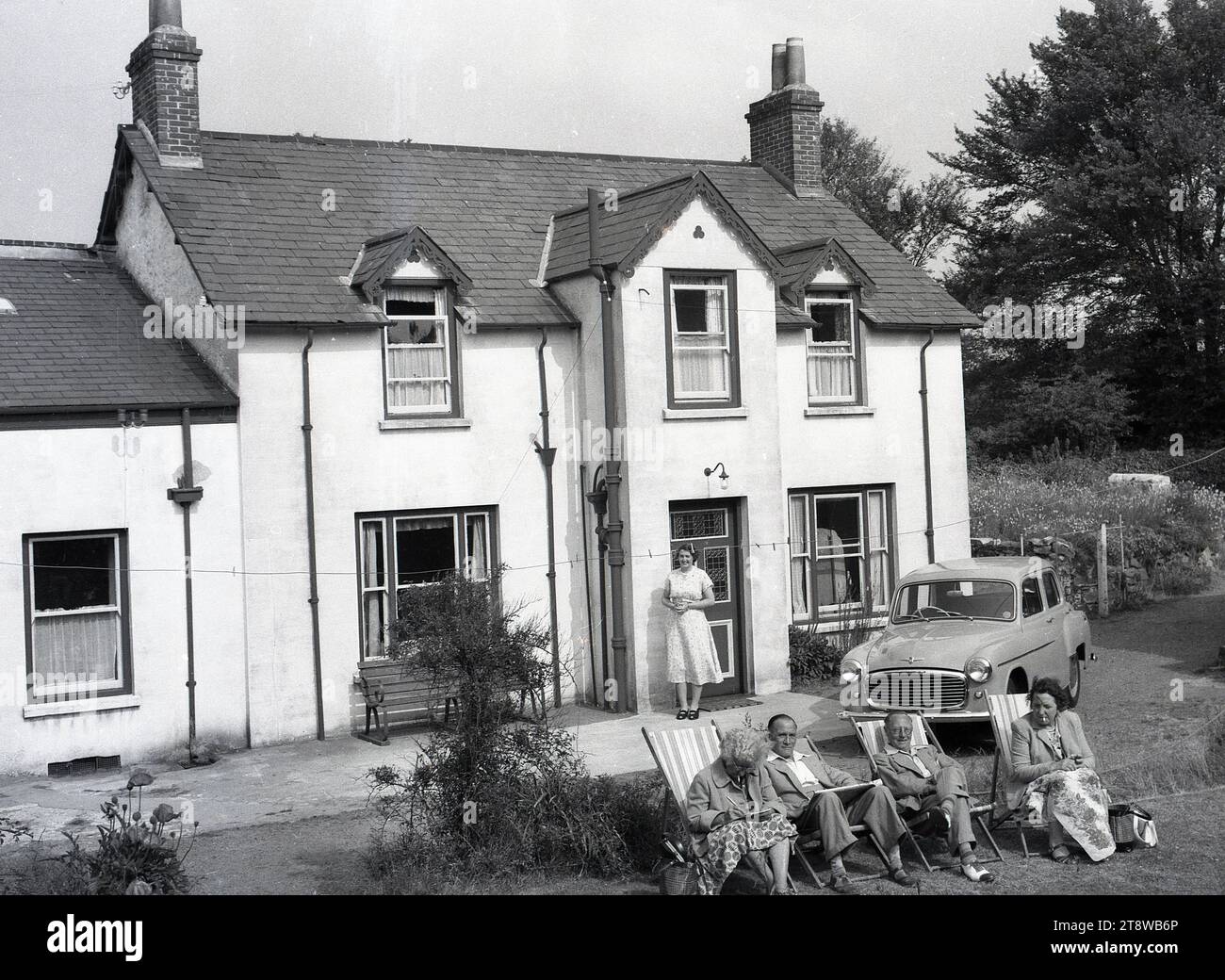 1950s, historical, family and car of the era outside a house, England ...