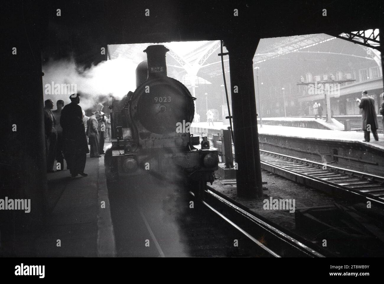 1950s, historical, a steam locomotive, no 9023, beside a platform at a ...