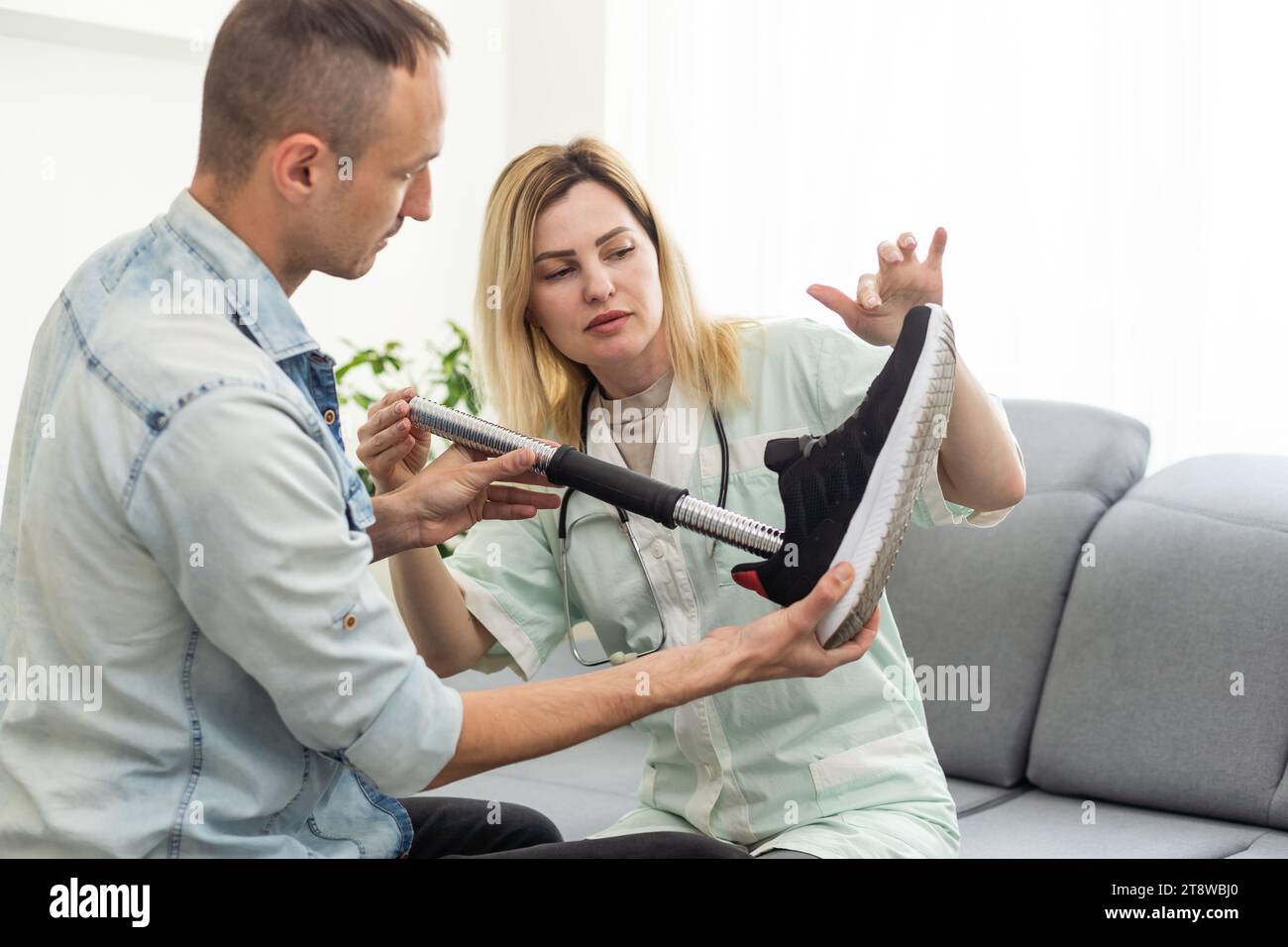 Modern Hospital Physical Therapy: Doctor Uses Tablet Computer, Helps ...