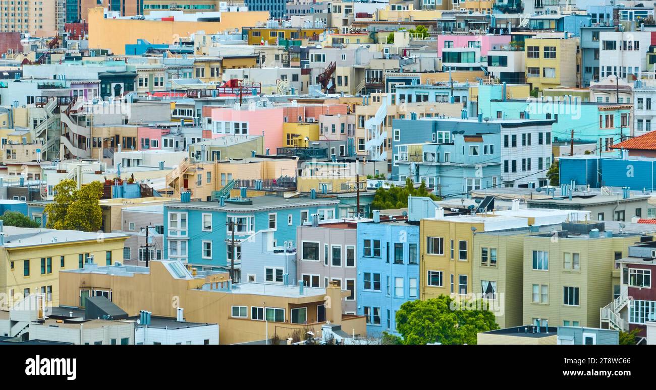Colorful apartment buildings in messy rows up hill in San Francisco, CA ...