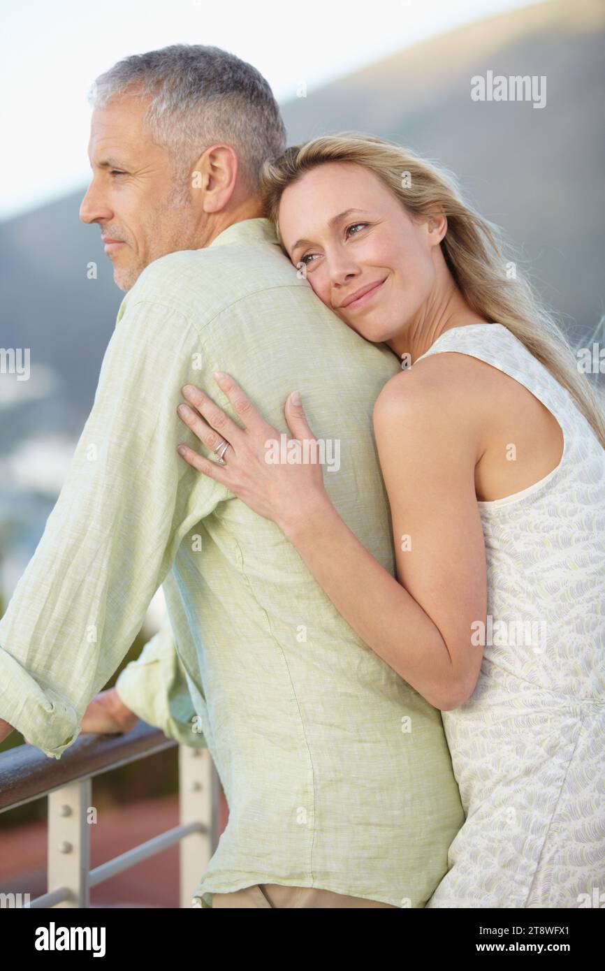 Happy couple, hug and love on balcony in marriage, embrace or care on ...