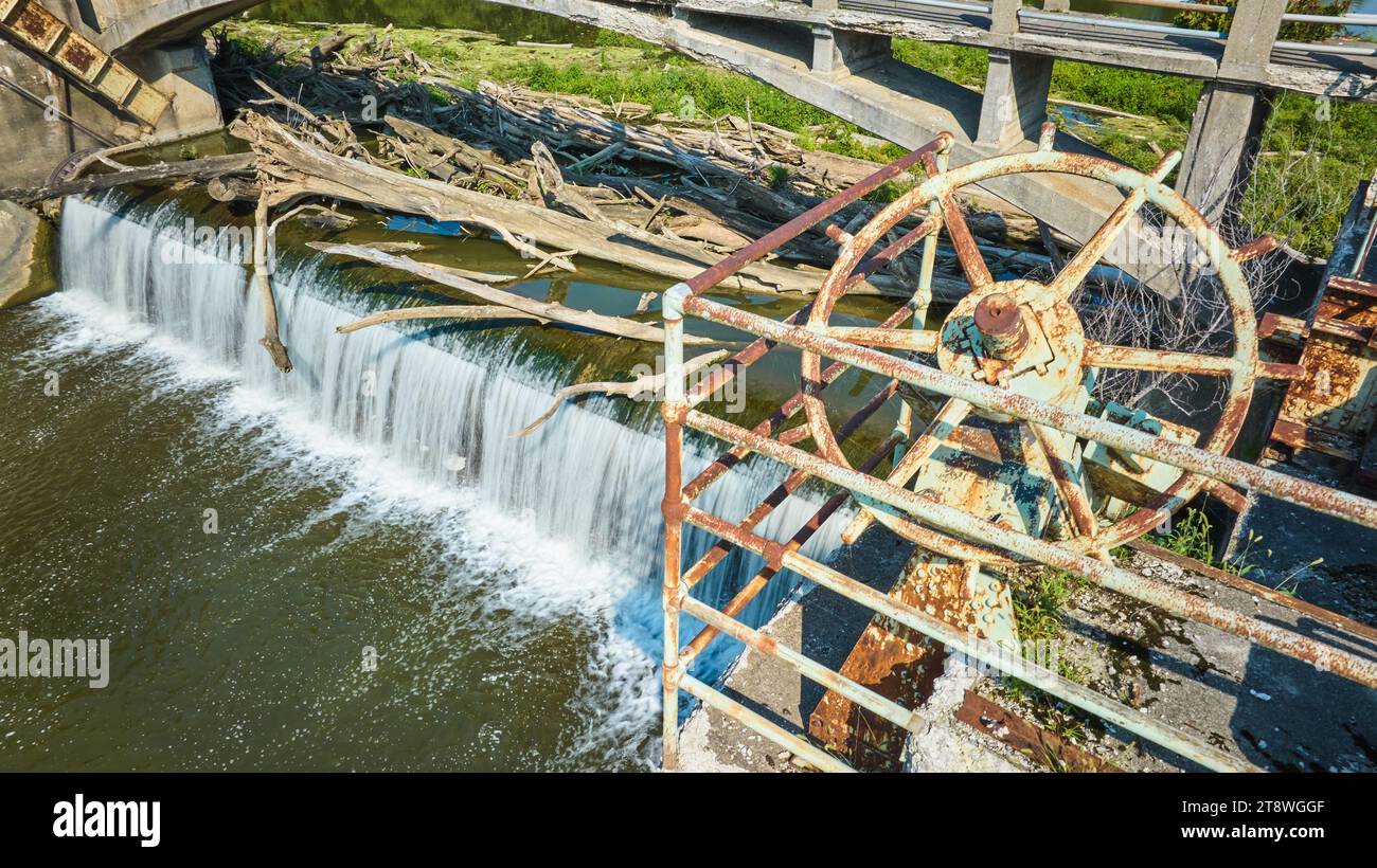 Maumee River Dam rusty wheel equipment and railing with logs above ...