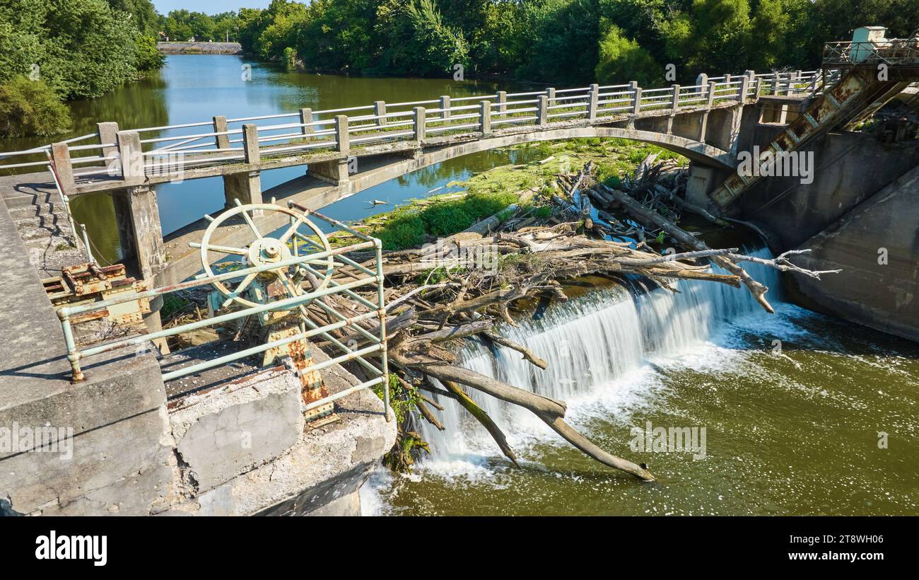 Rusty wheel Maumee River Dam with logs and algae growth above waterfall ...