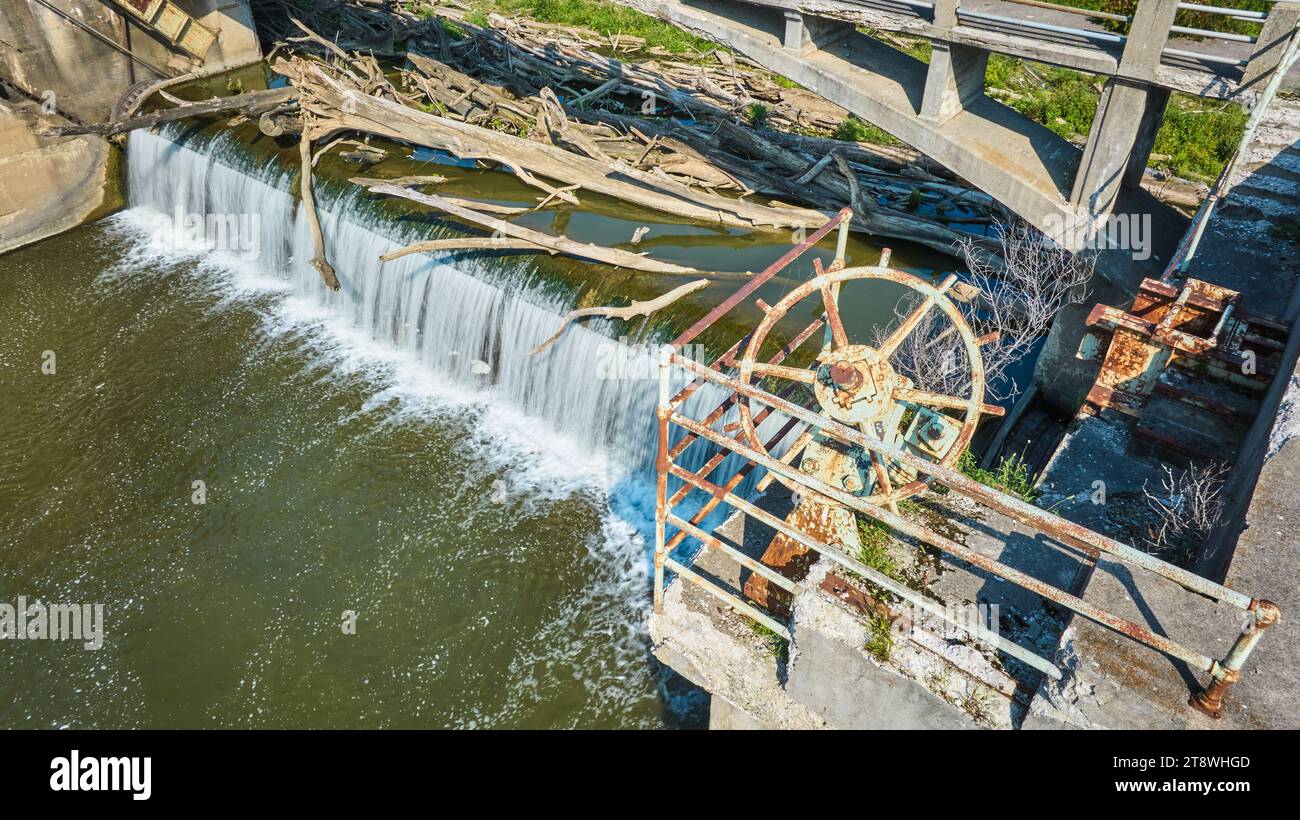 Rusty wheel equipment and railing of Maumee River Dam choked by logs ...