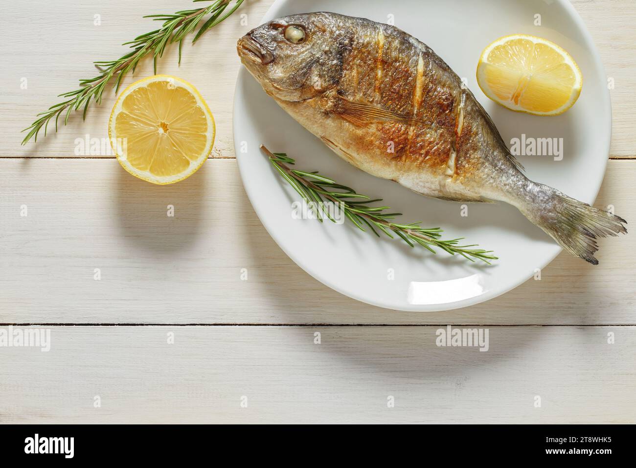 Dorado, cooked, grilled fish fried, rosemary, cut lemons, source of ...