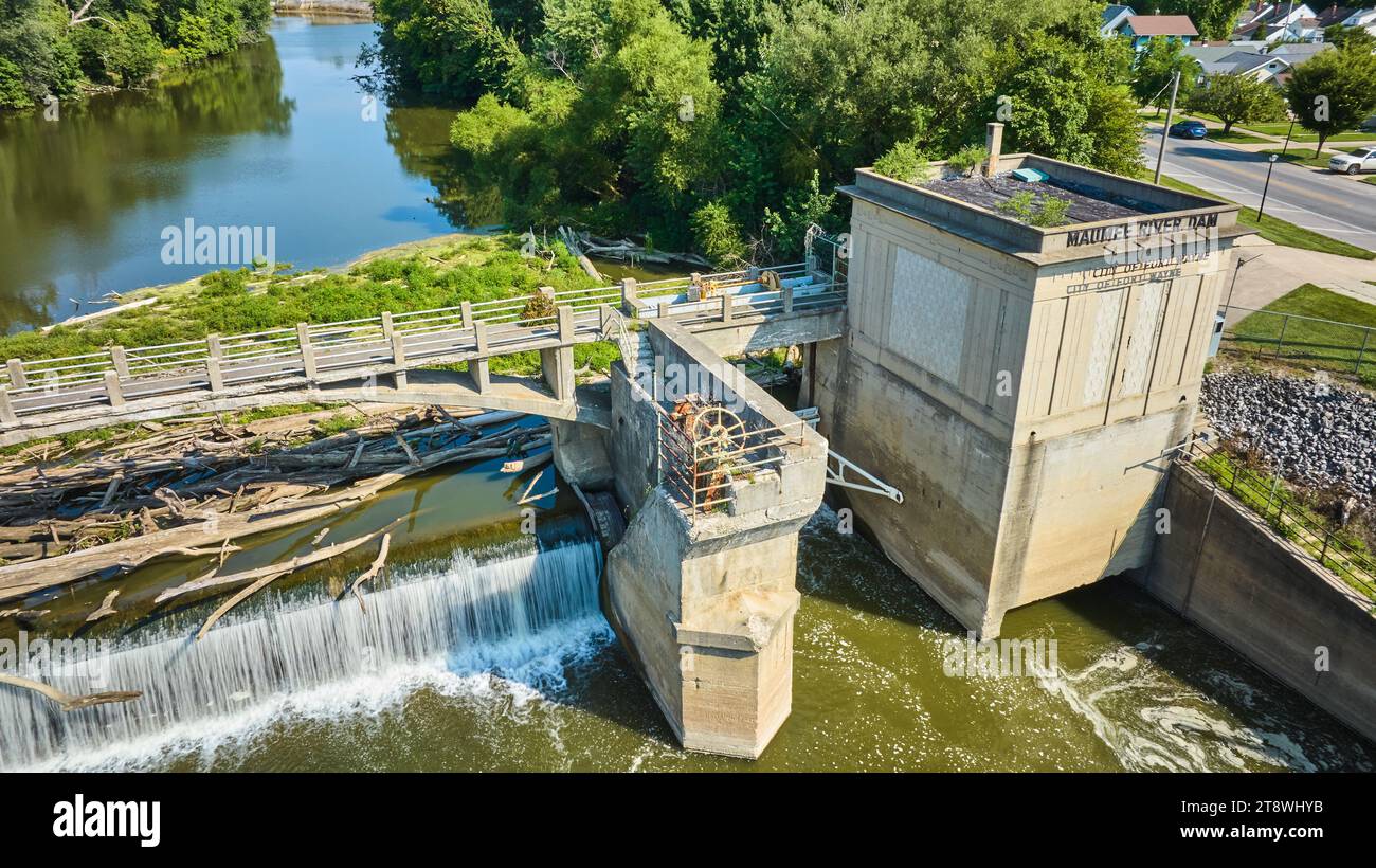 Rusty Maumee River Dam wheel above tree logs under bridge choking ...
