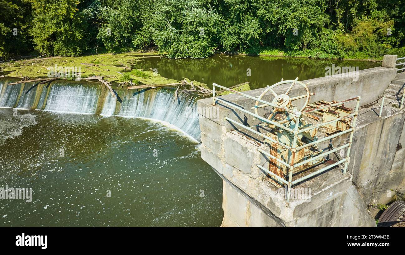 Rusty wheel Maumee River Dam with logs and algae growth above waterfall ...