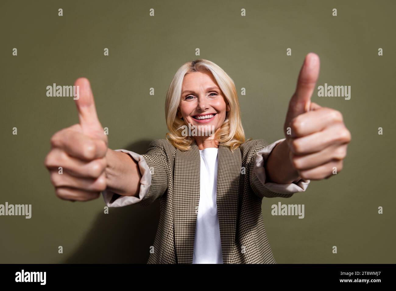 Portrait of satisfied cheerful mature businesswoman thumbs up closeup ...