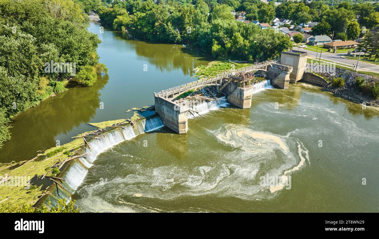 Maumee River Dam swirling water with waterfalls chocked by tree logs ...