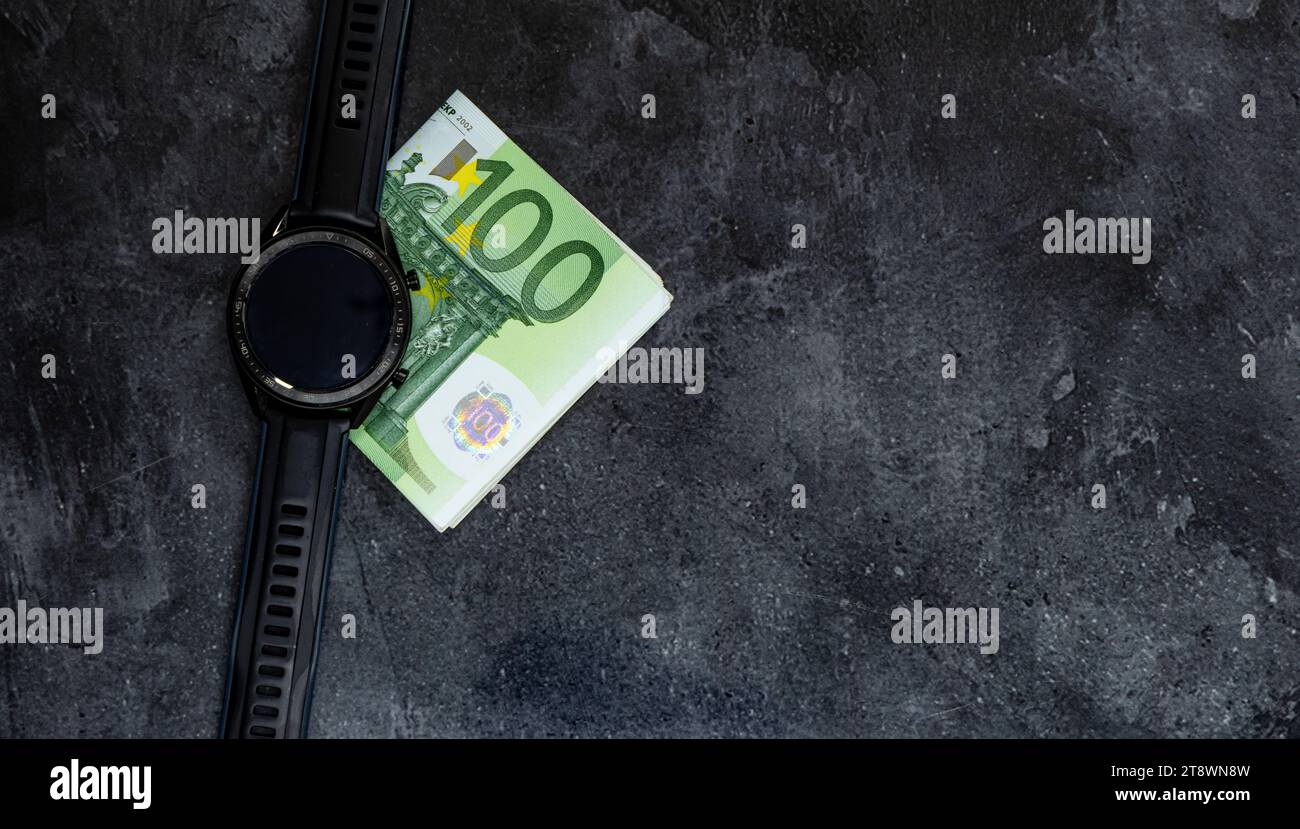 Time is money, watch on the table, euro banknotes cash Stock Photo - Alamy