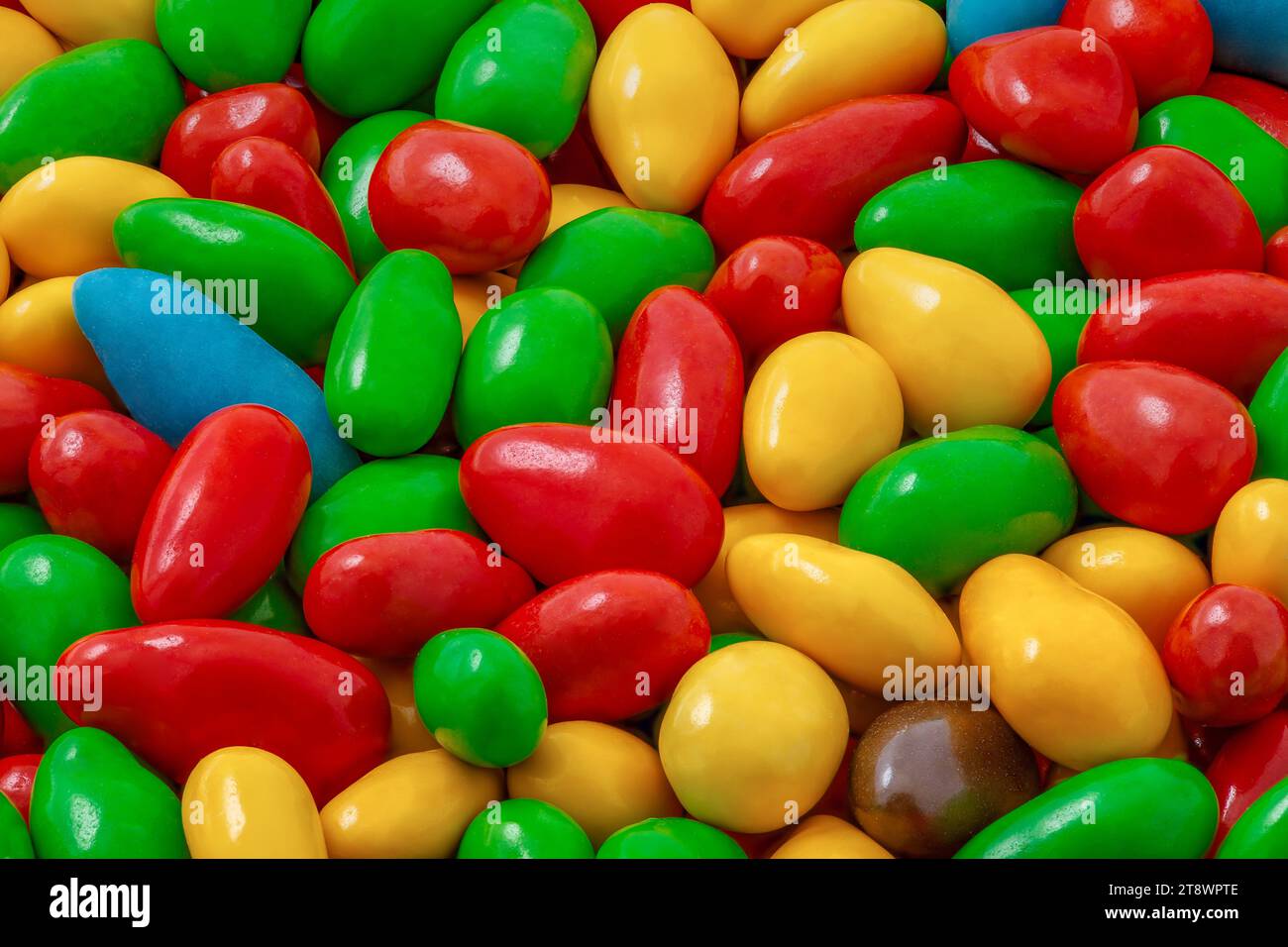 Candy in multi colored glaze in bulk, close-up macro, mini pieces ...