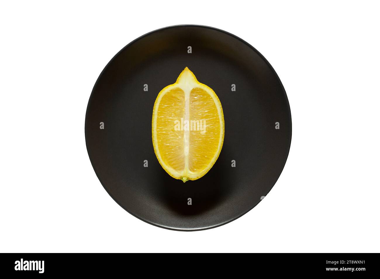 Lemon cut lengthwise, on gray plate, isolated on white background with ...