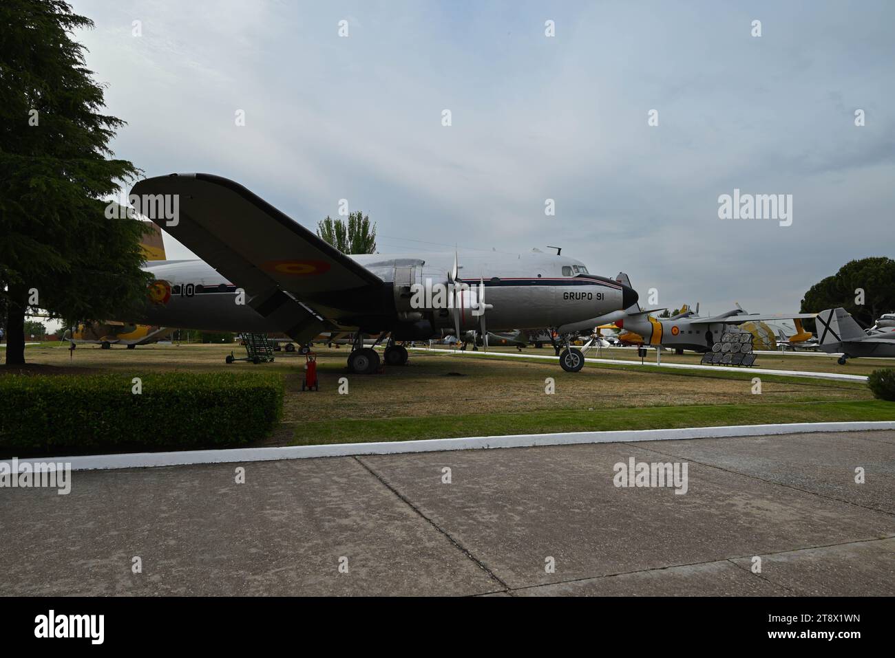 Two airplanes on display in an open grass field surrounded by trees ...