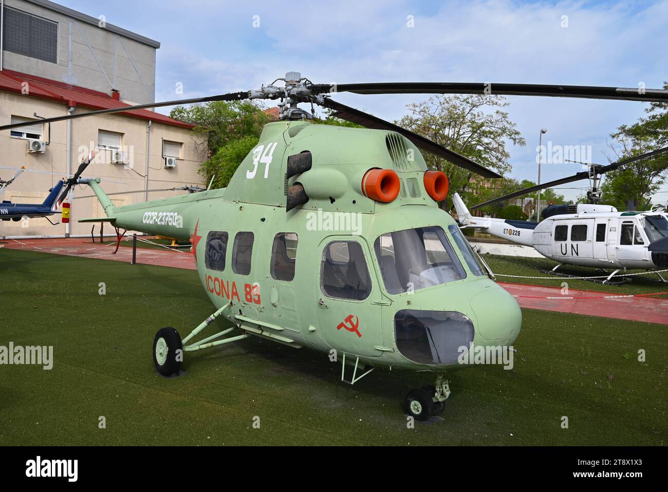 A black and silver helicopter is prominently placed in an outdoor ...