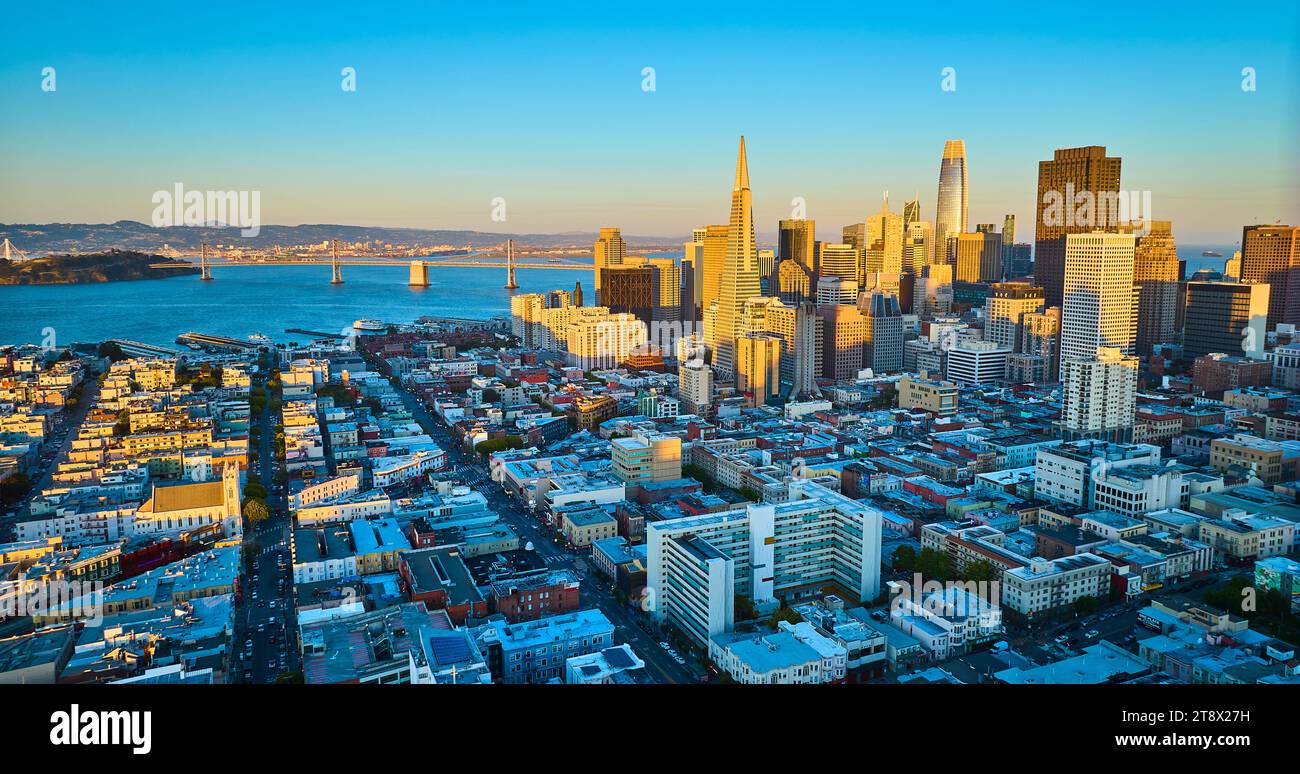 San Francisco city sunset aerial above buildings with some in shadow ...
