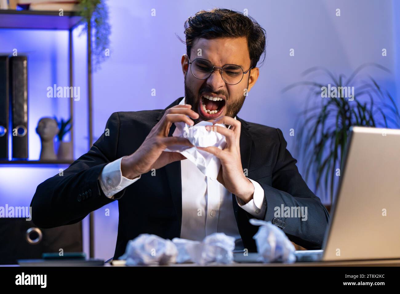 Angry furious Indian man working at office throwing crumpled paper ...