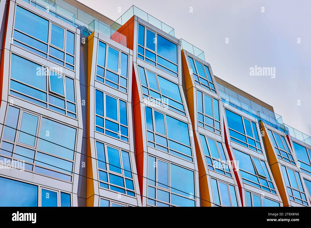 Bright blue windows with jutting out walls and tilted sections of ...