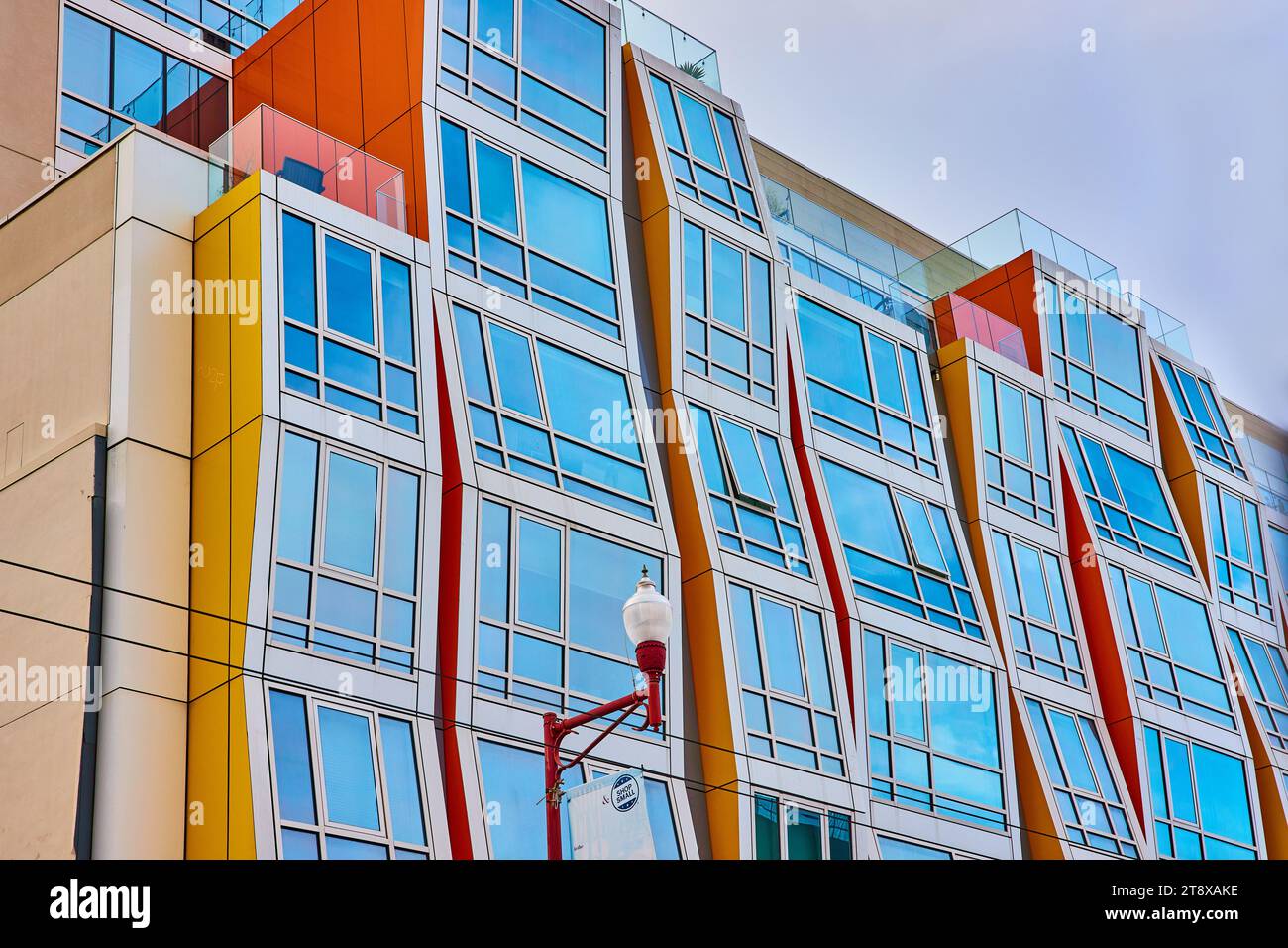 Colorful architecture of tilted blue windows on unique building with ...