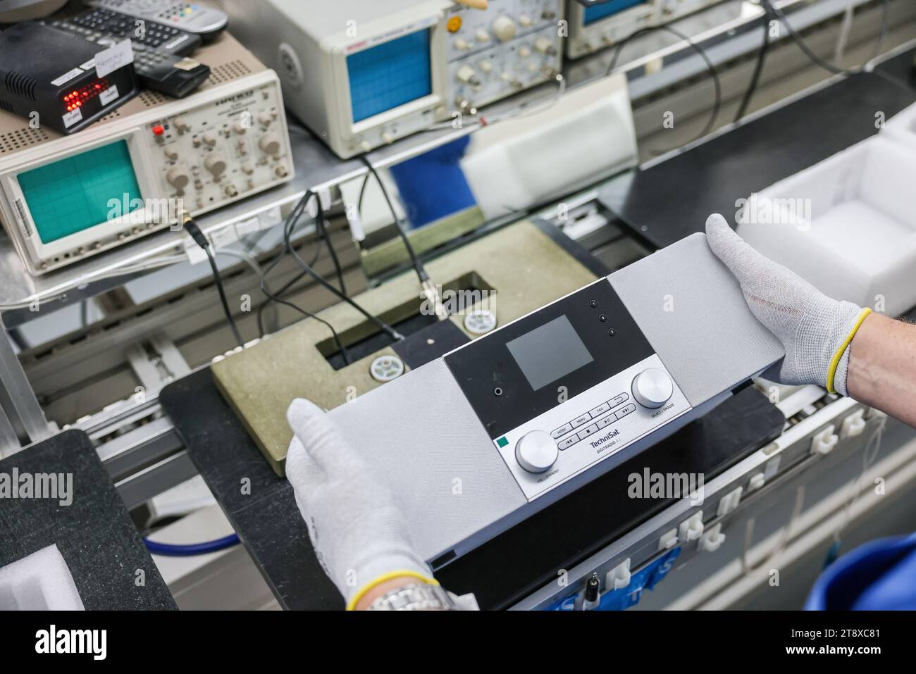17 November 2023, Saxony, Schöneck: An employee assembles a digital ...