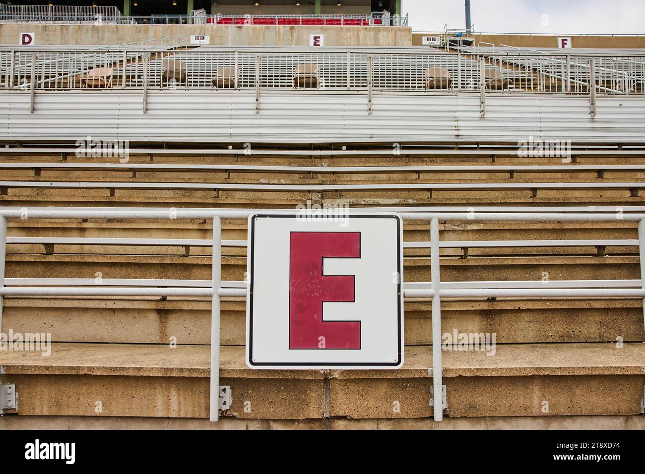 E, D, F sections of empty stands at sports stadium under gloomy sky on ...