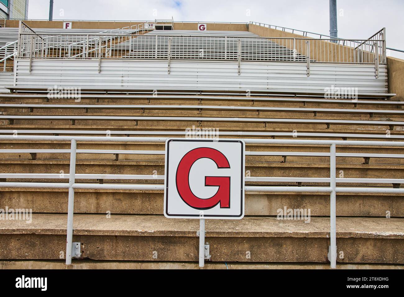 G and F section of empty stands at sports stadium under gloomy sky on ...