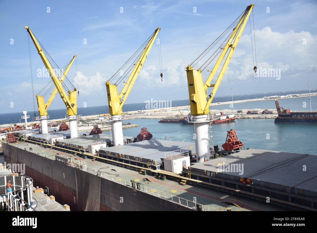 Marine cranes on a ship at Progresso port in Mexico. Marine cranes are ...