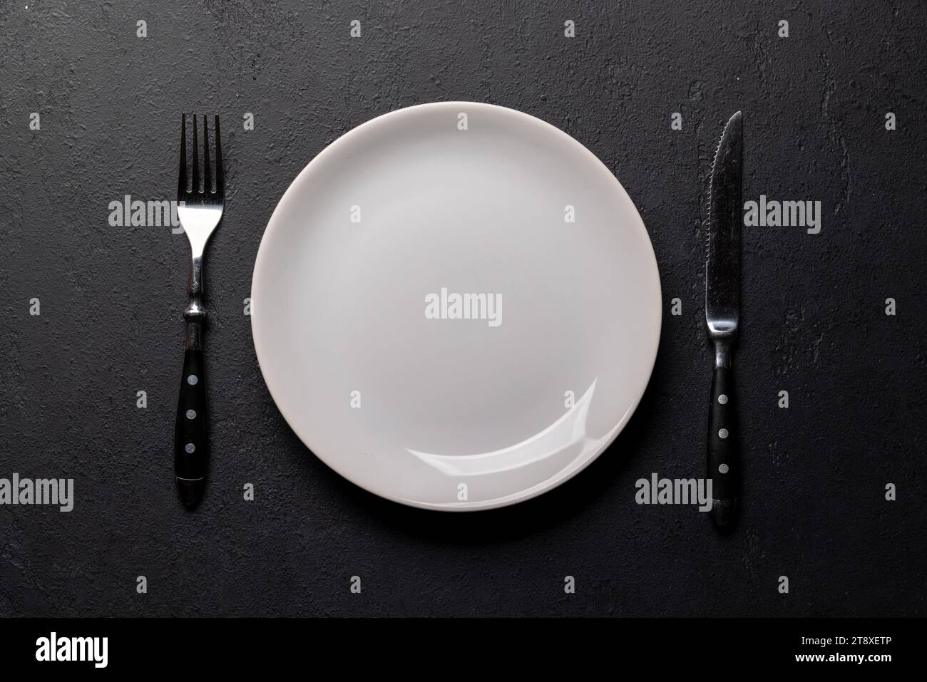 Mockup for a delicious meal. Empty plate on a table. Flat lay with copy ...