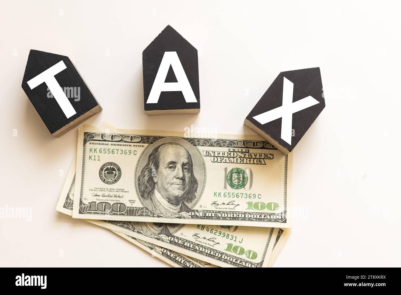 Tax text in wooden cubes and tax or vat form documents to complete ...