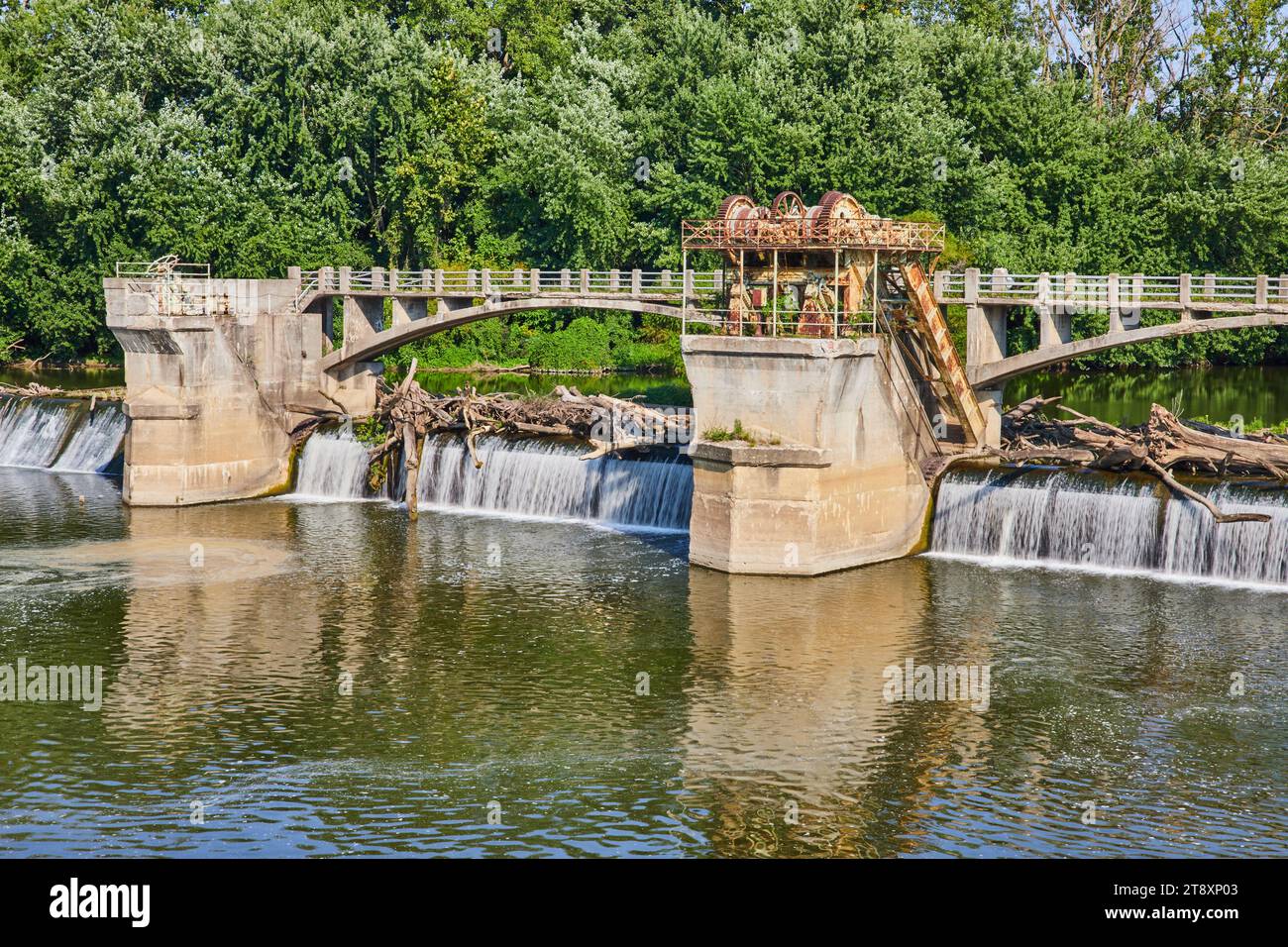 Rusty Maumee River Dam equipment on concrete pillars holding back tree ...