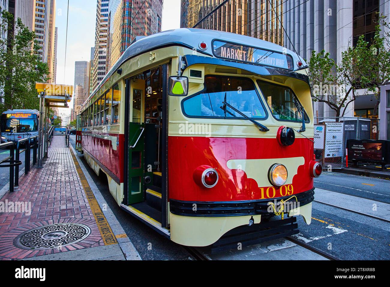 Red and cream streetcar in downtown city street San Francisco front and ...